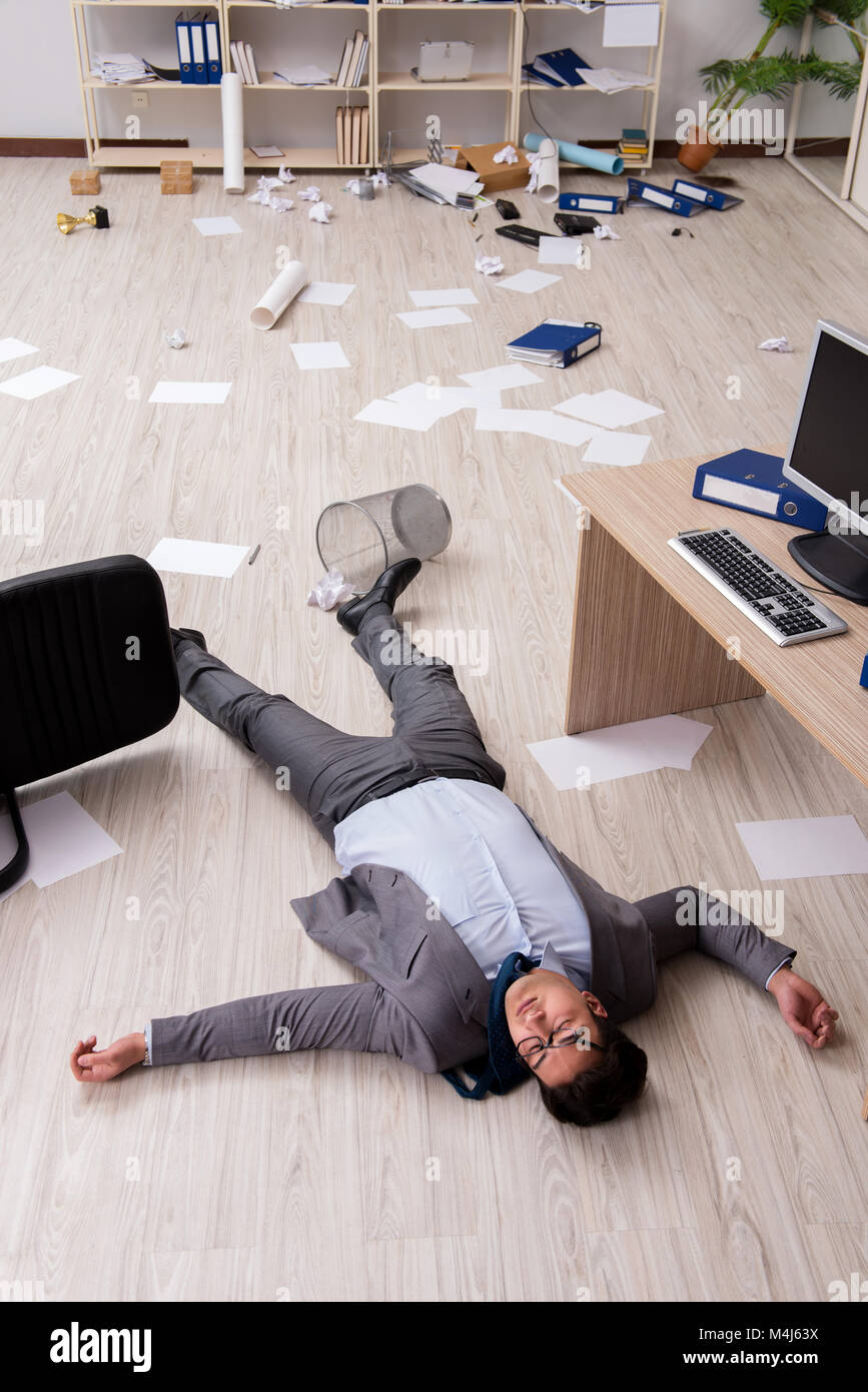 Businessman dead on the office floor Stock Photo - Alamy