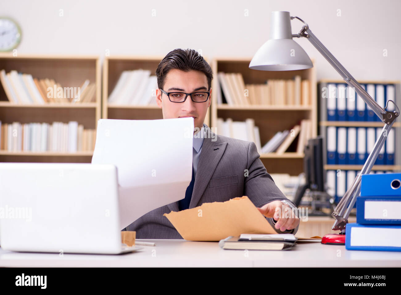 Businessman receiving letter in the office Stock Photo - Alamy