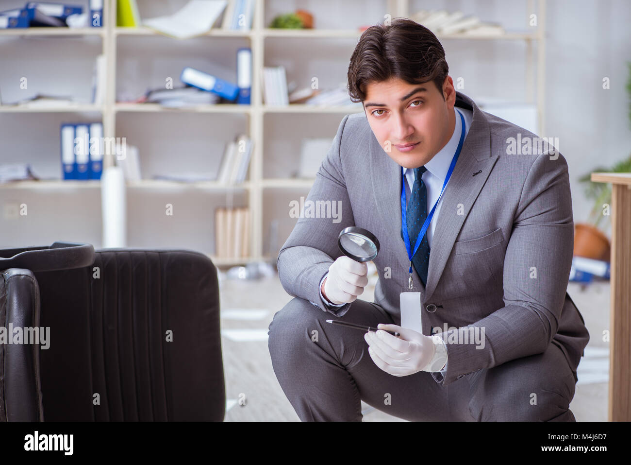 Young man during crime investigation in office Stock Photo - Alamy