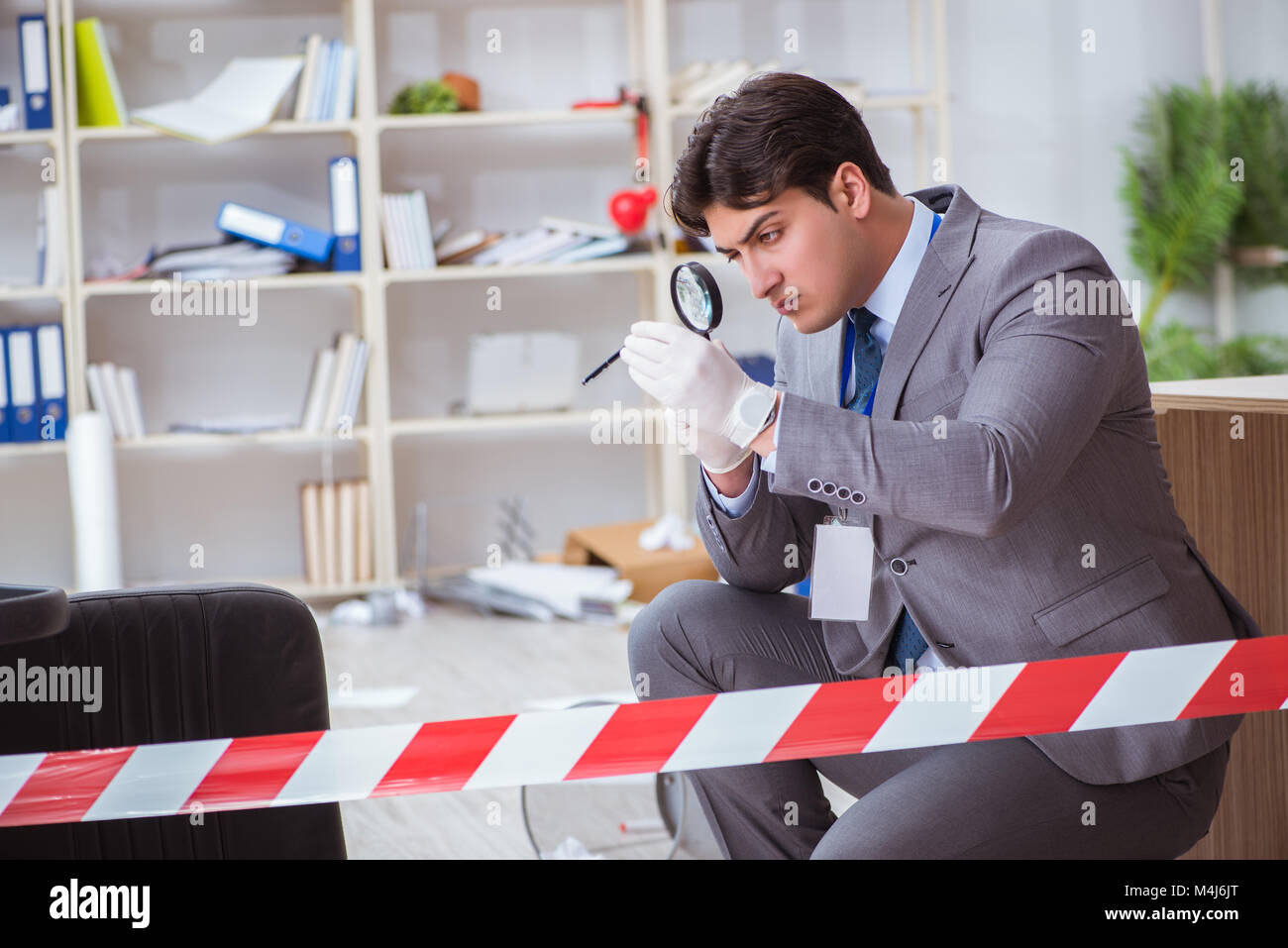 Young man during crime investigation in office Stock Photo - Alamy