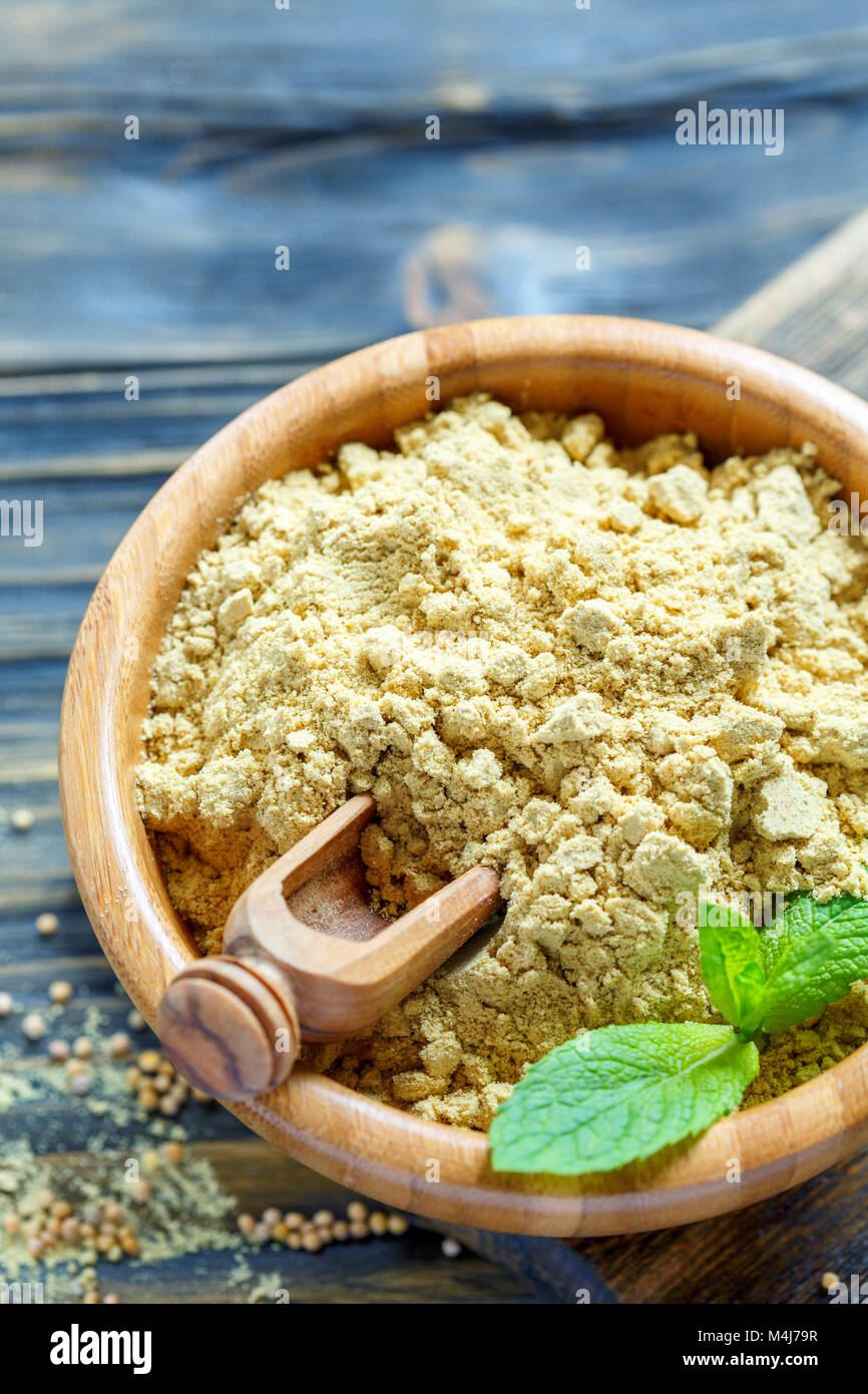Wooden bowl with the mustard powder Stock Photo - Alamy
