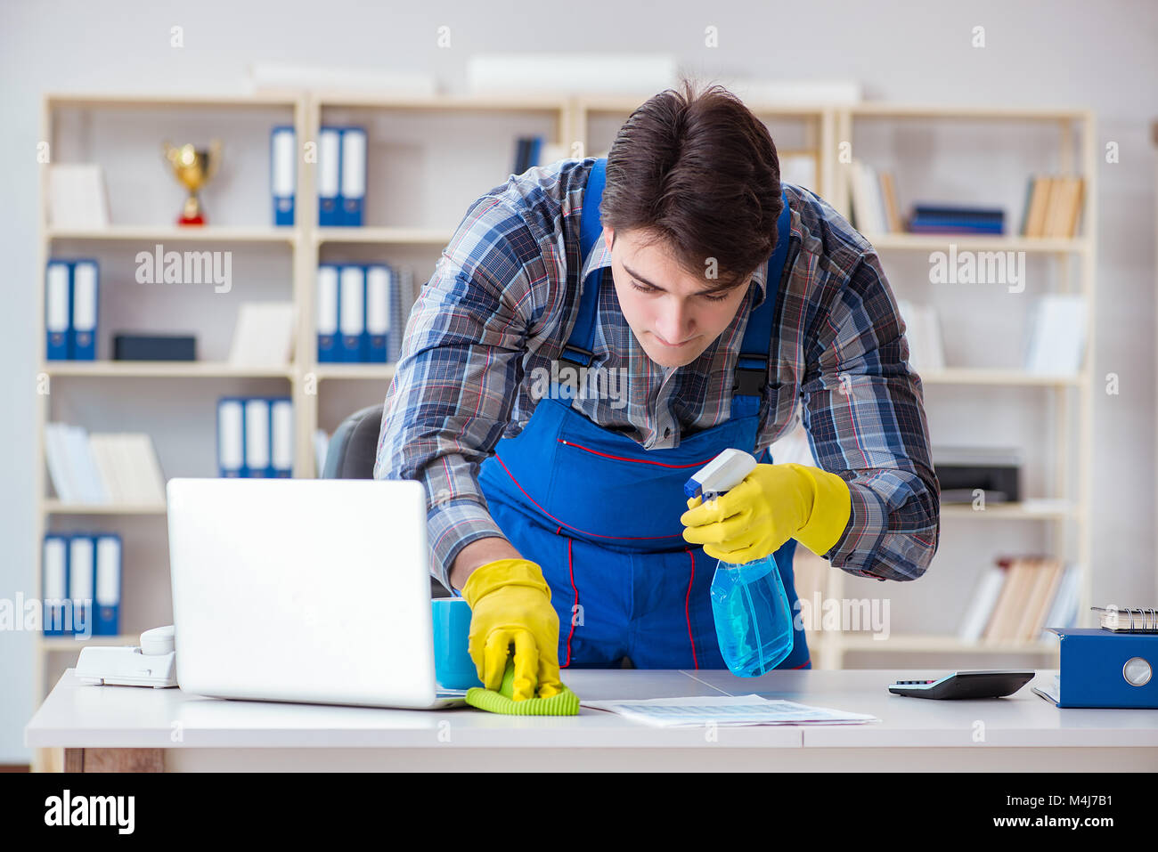 Male cleaner working in the office Stock Photo - Alamy