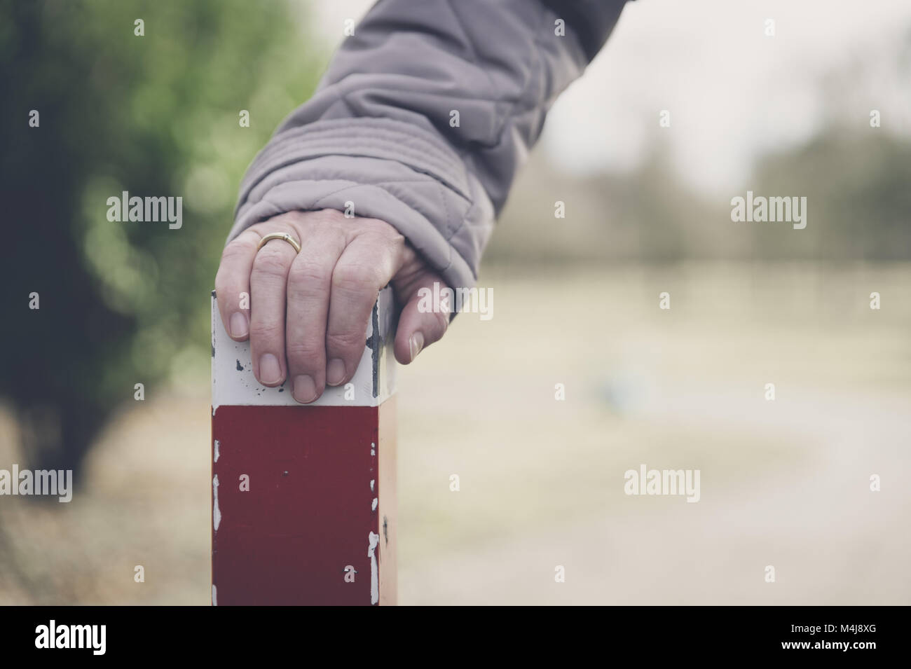 Hand on post Stock Photo - Alamy