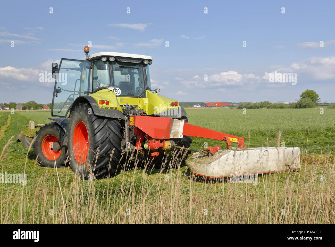 A tractor at the haymaking Stock Photo - Alamy