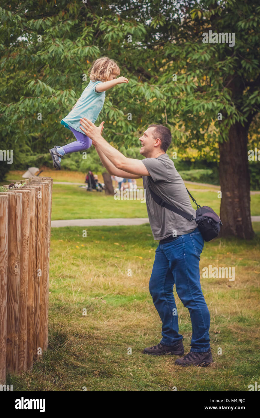 Father catching daughter Stock Photo - Alamy
