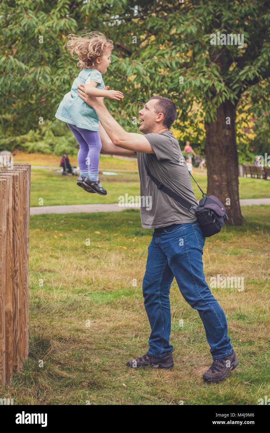 Father catching daughter Stock Photo - Alamy