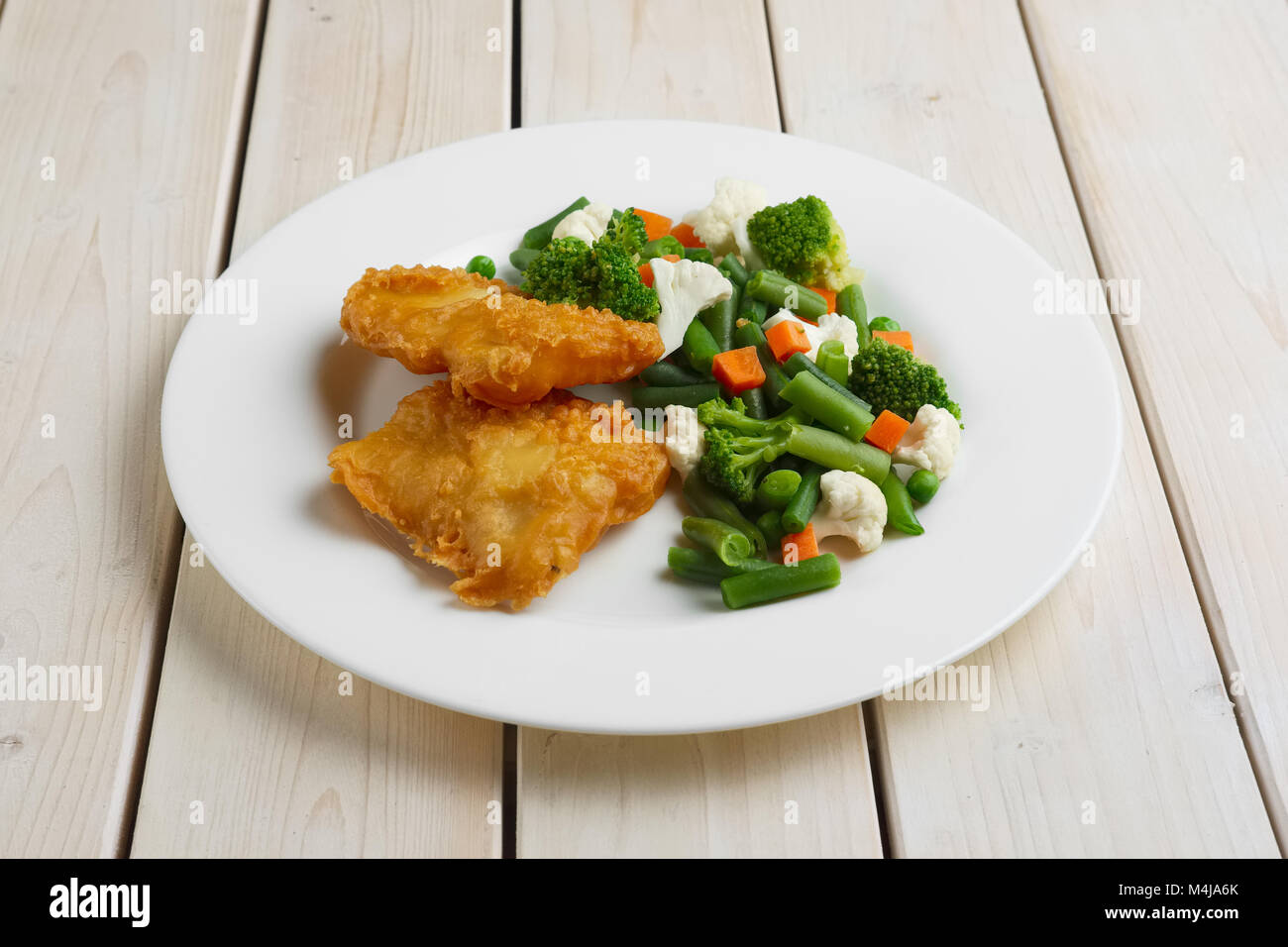 fish fillet in batter with boiled vegetables Stock Photo - Alamy