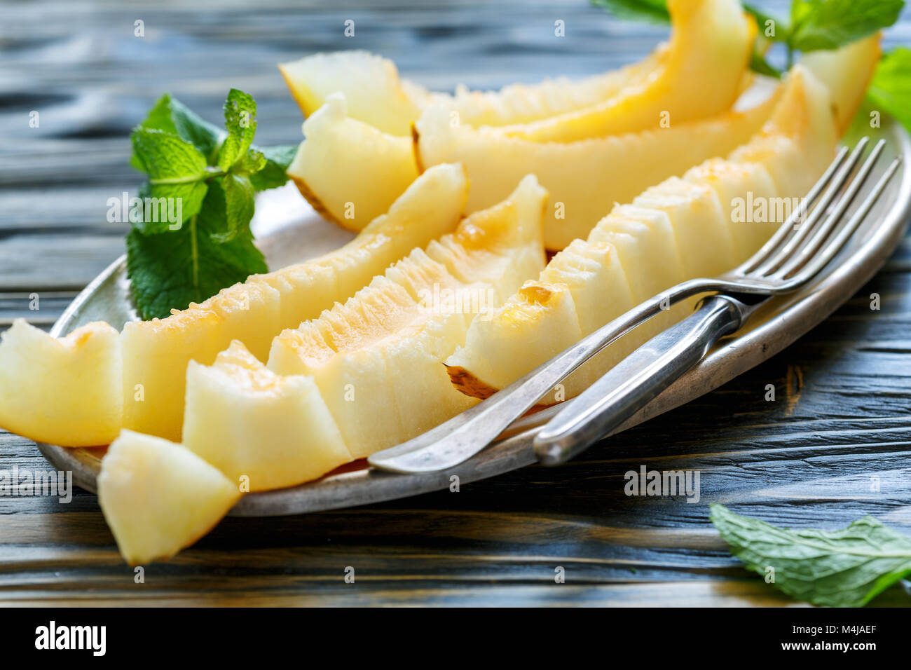 Fresh sweet melon sliced on a tray Stock Photo - Alamy