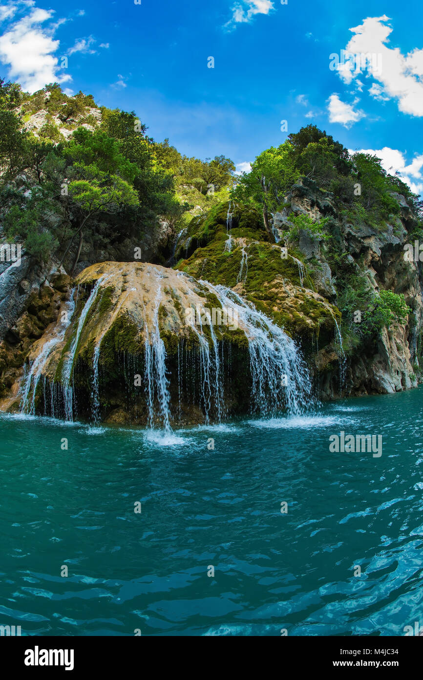 The picturesque azure waterfall on the side wall Stock Photo - Alamy
