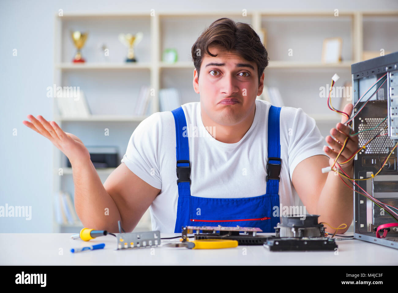 Computer repairman repairing desktop computer Stock Photo - Alamy