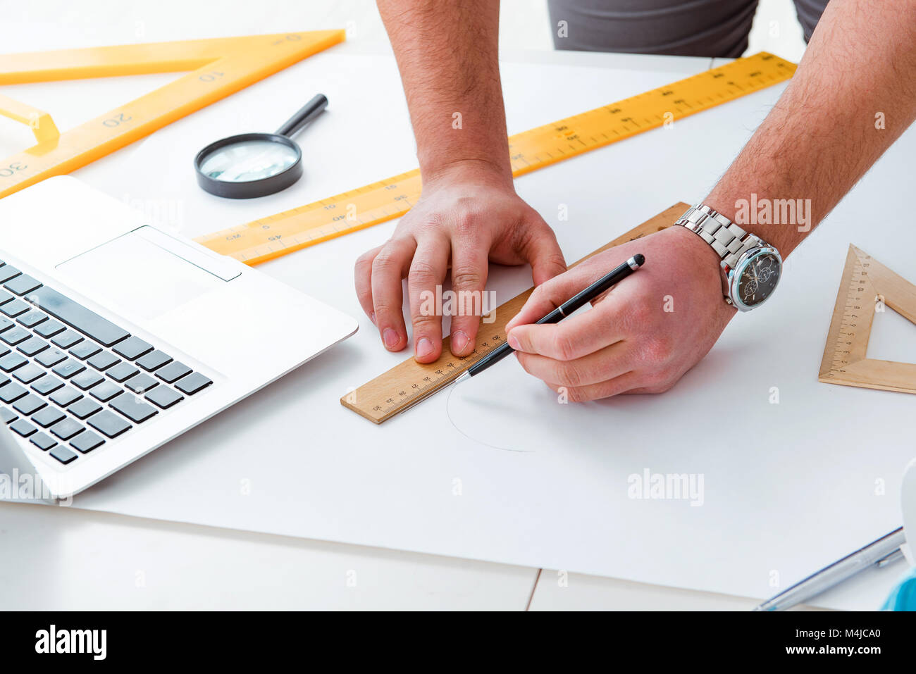 Male engineer working on drawings and blueprints Stock Photo - Alamy