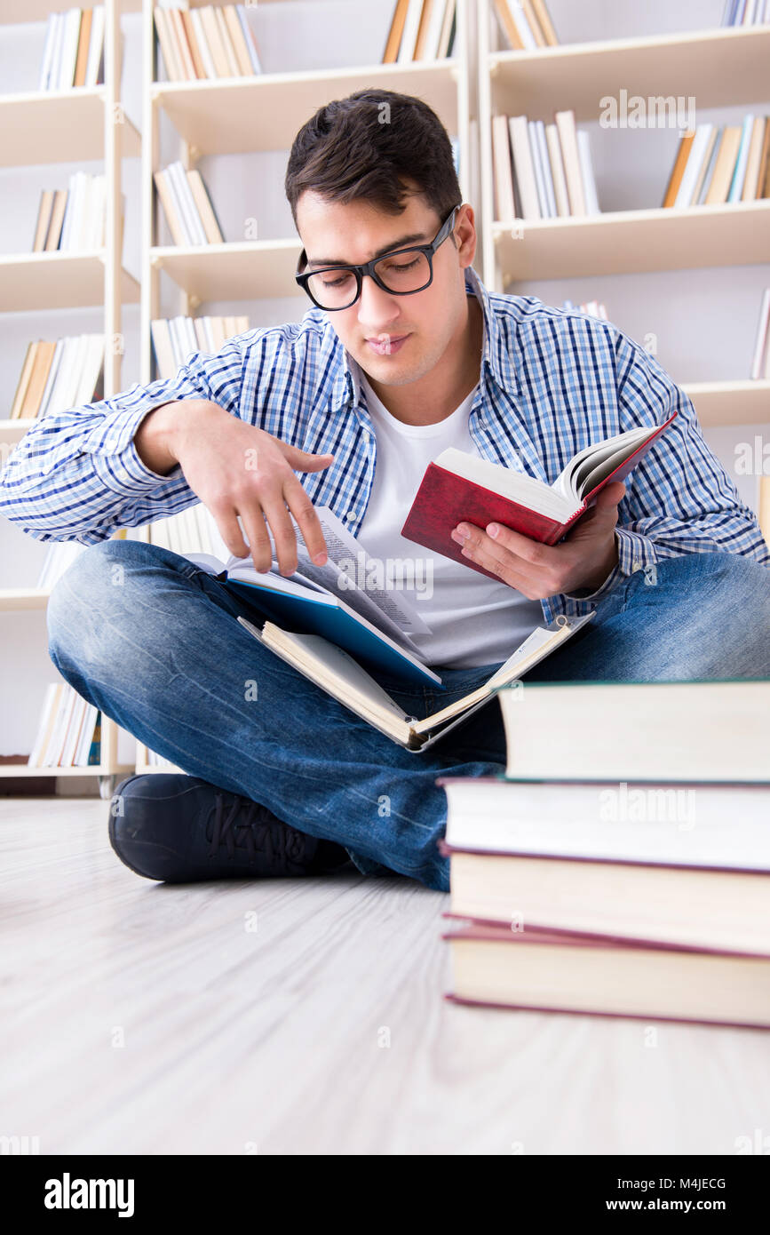 Young student studying with books Stock Photo - Alamy