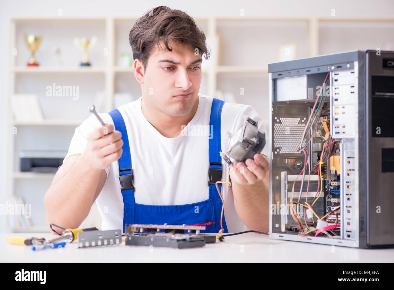 Computer repairman repairing desktop computer Stock Photo - Alamy