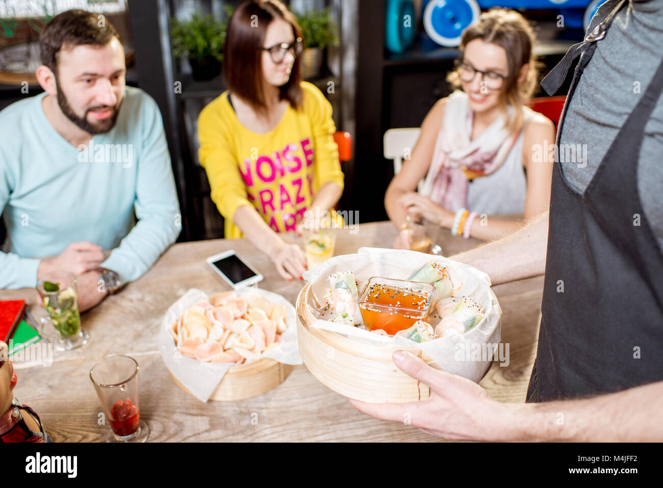 Chinese waiter serving food hi-res stock photography and images - Alamy