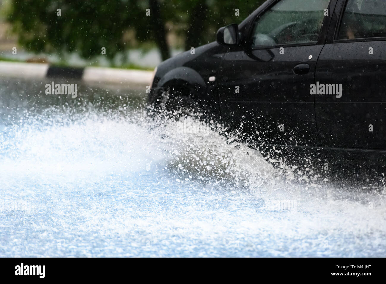 car rain puddle splashing water Stock Photo - Alamy