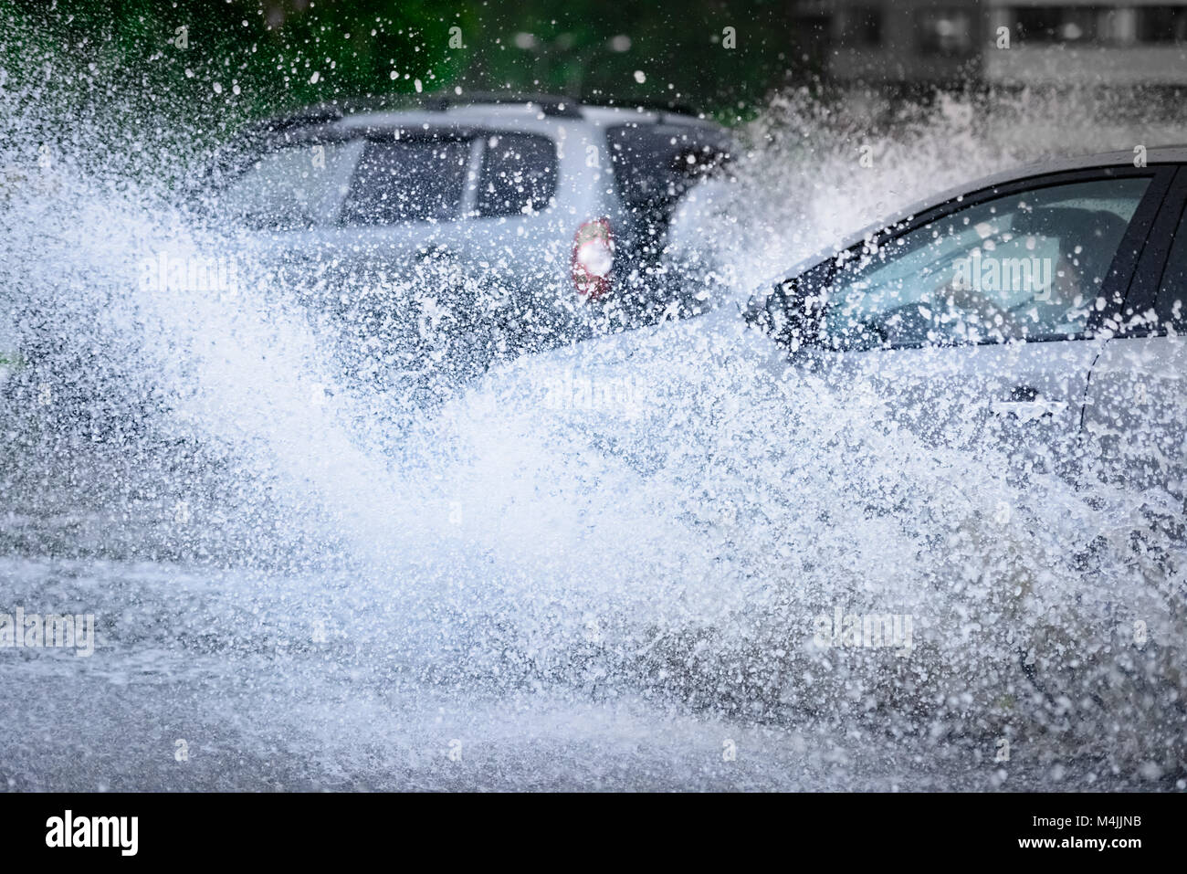 car rain puddle splashing water Stock Photo - Alamy