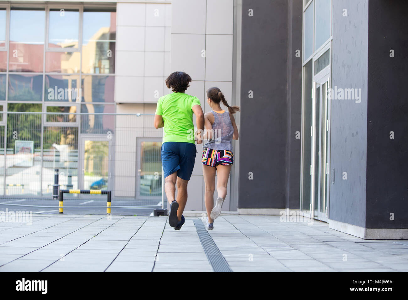 Back view at couple running outdoor Stock Photo - Alamy