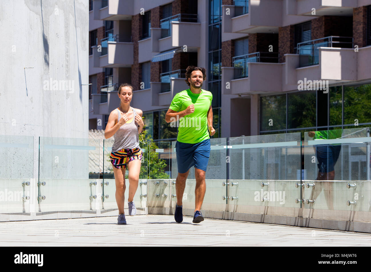 Couple running in urban enviroment at hot summer day Stock Photo - Alamy