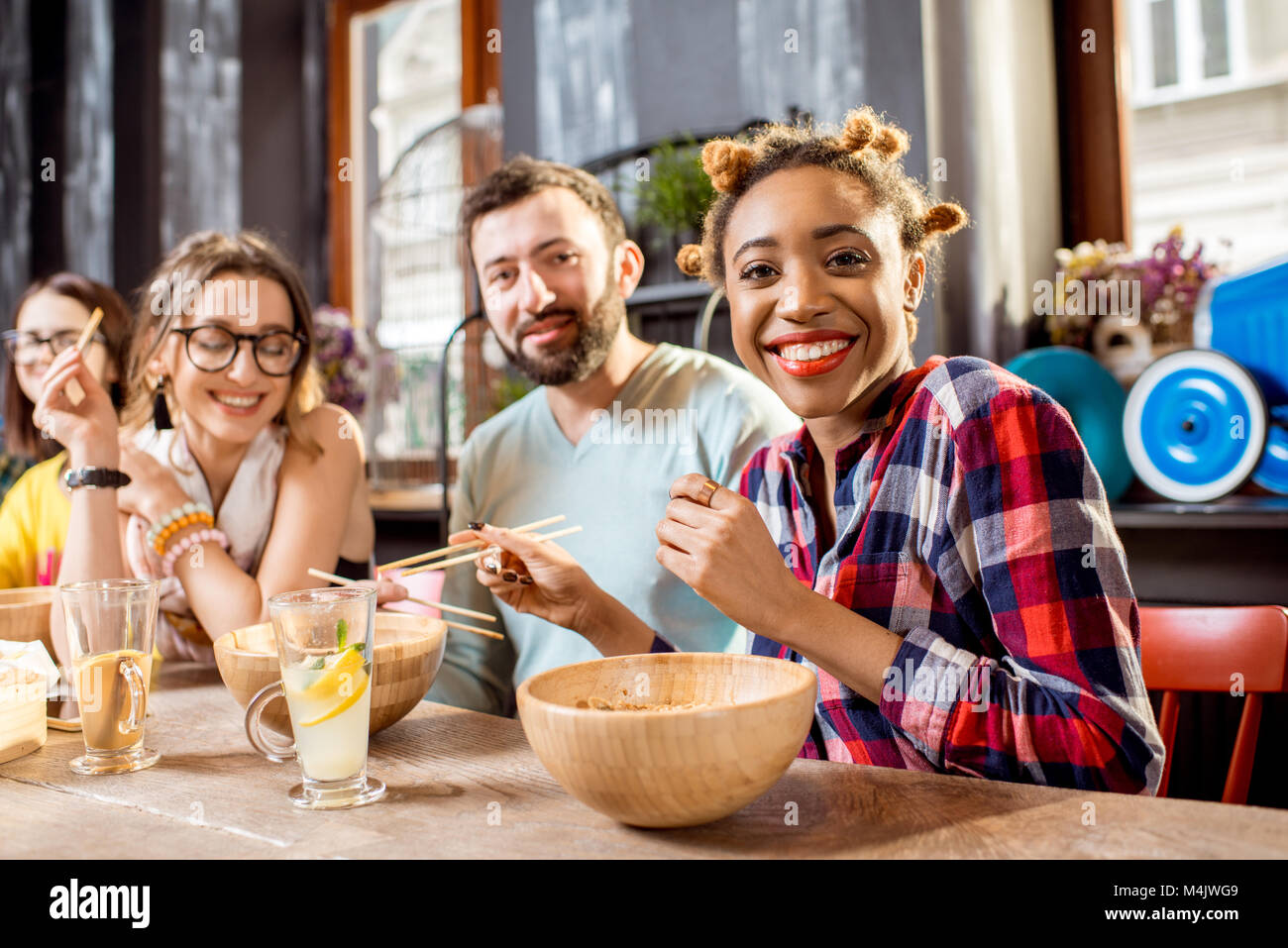 Diverse friends laughing wooden hi-res stock photography and images - Alamy