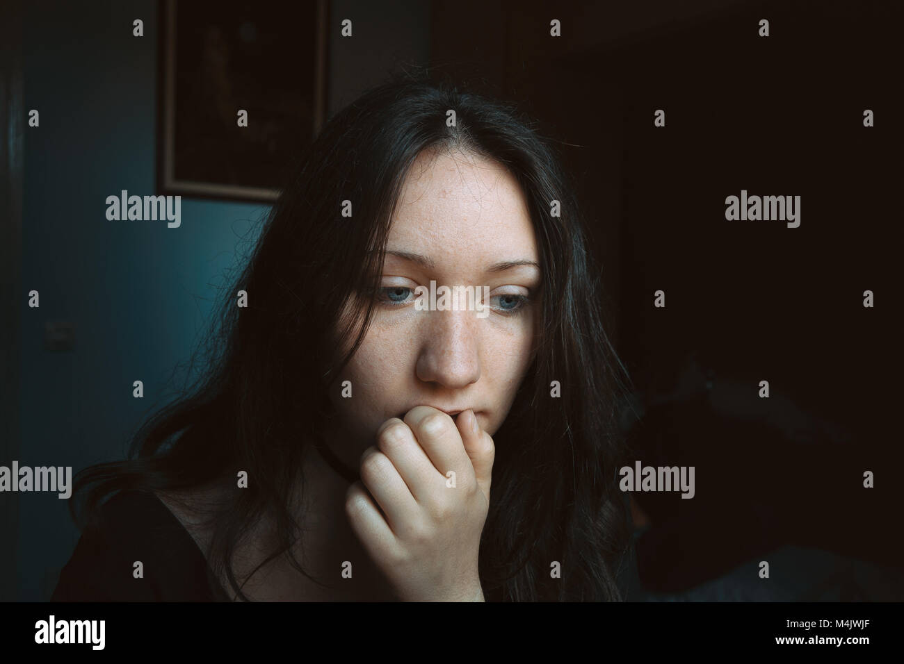 thoughtful girl with her hand on her lips Stock Photo - Alamy