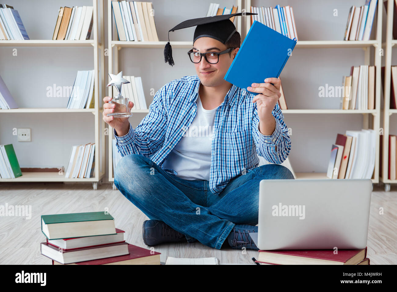 Young student studying with books Stock Photo - Alamy
