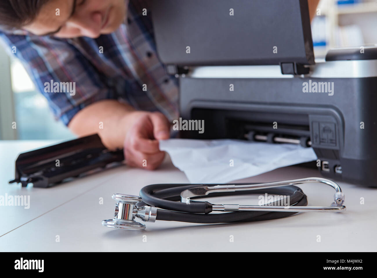 Repairman repairing broken color printer Stock Photo - Alamy