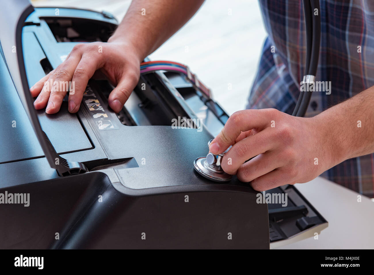 Repairman repairing broken color printer Stock Photo - Alamy