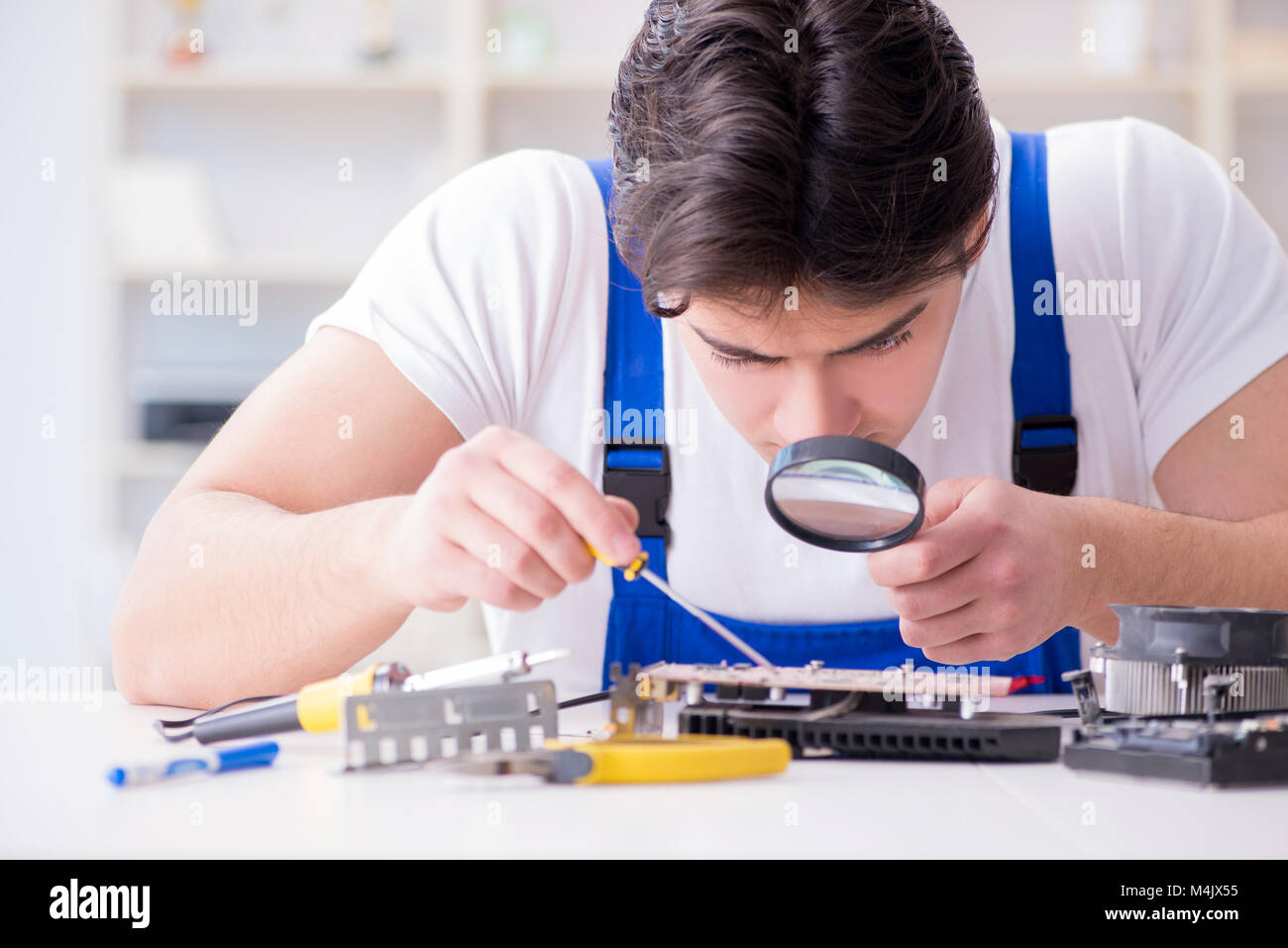 Computer repairman repairing desktop computer Stock Photo - Alamy