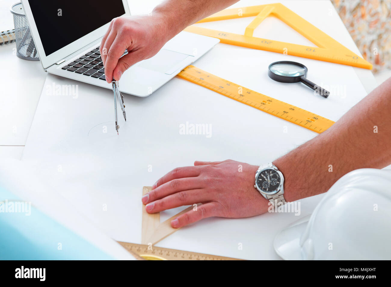 Male engineer working on drawings and blueprints Stock Photo - Alamy