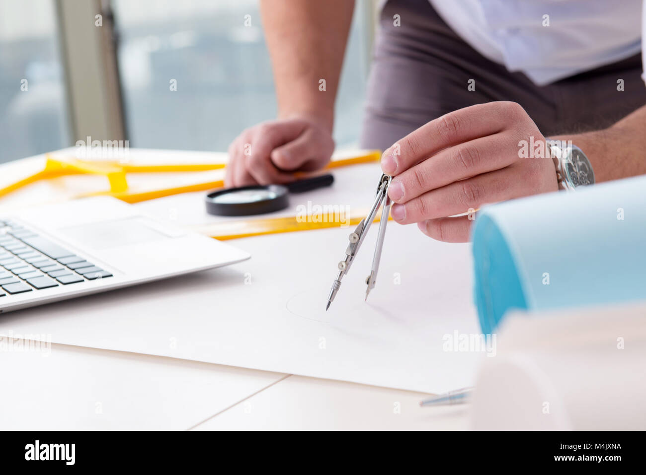 Male engineer working on drawings and blueprints Stock Photo - Alamy