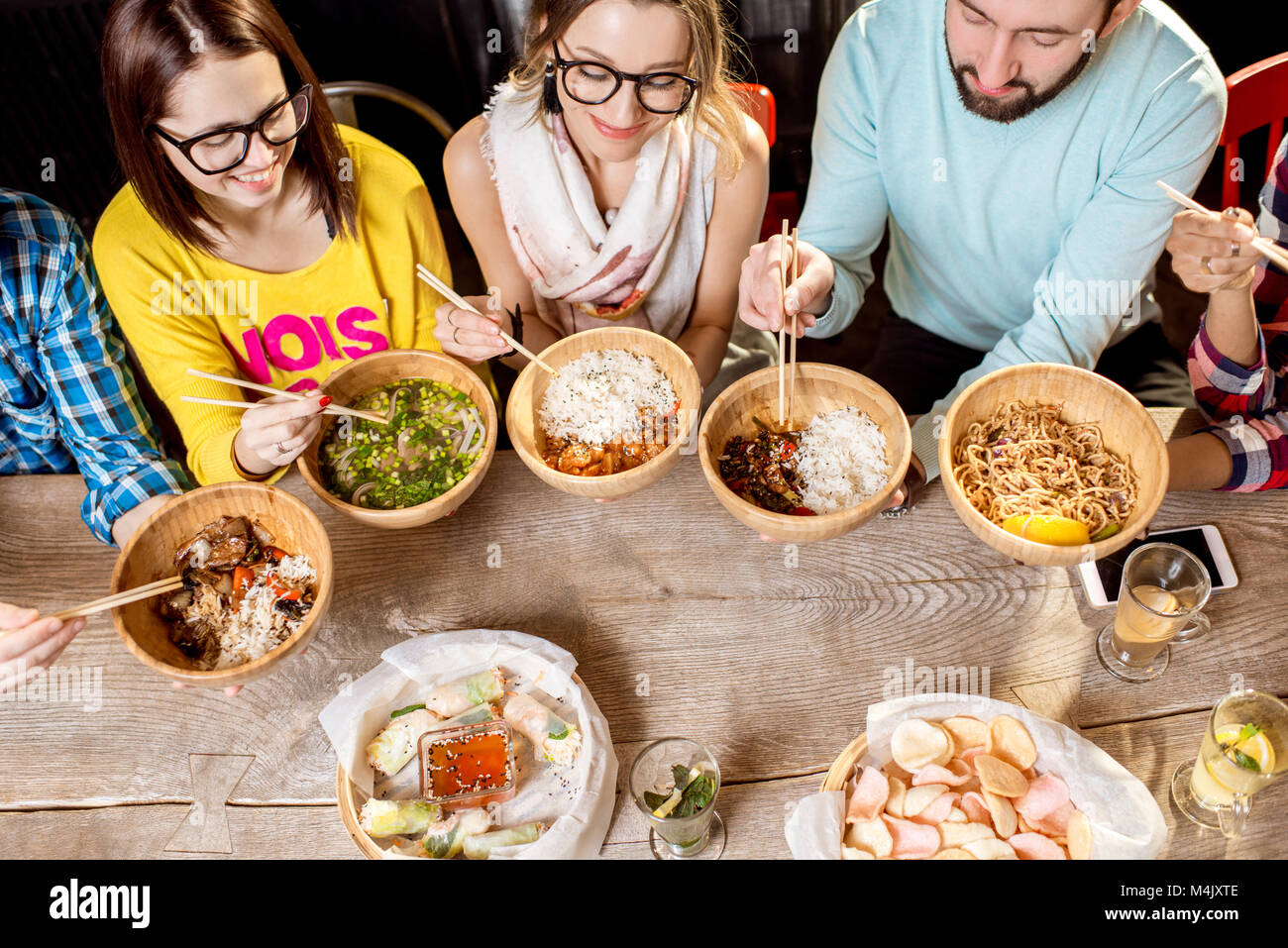 Friends eating asian meals Stock Photo - Alamy