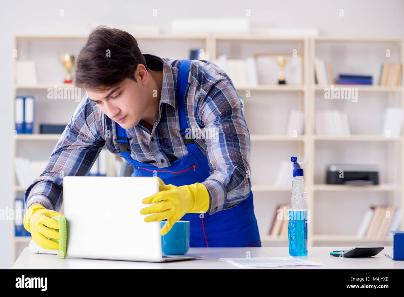 Male cleaner working in the office Stock Photo - Alamy