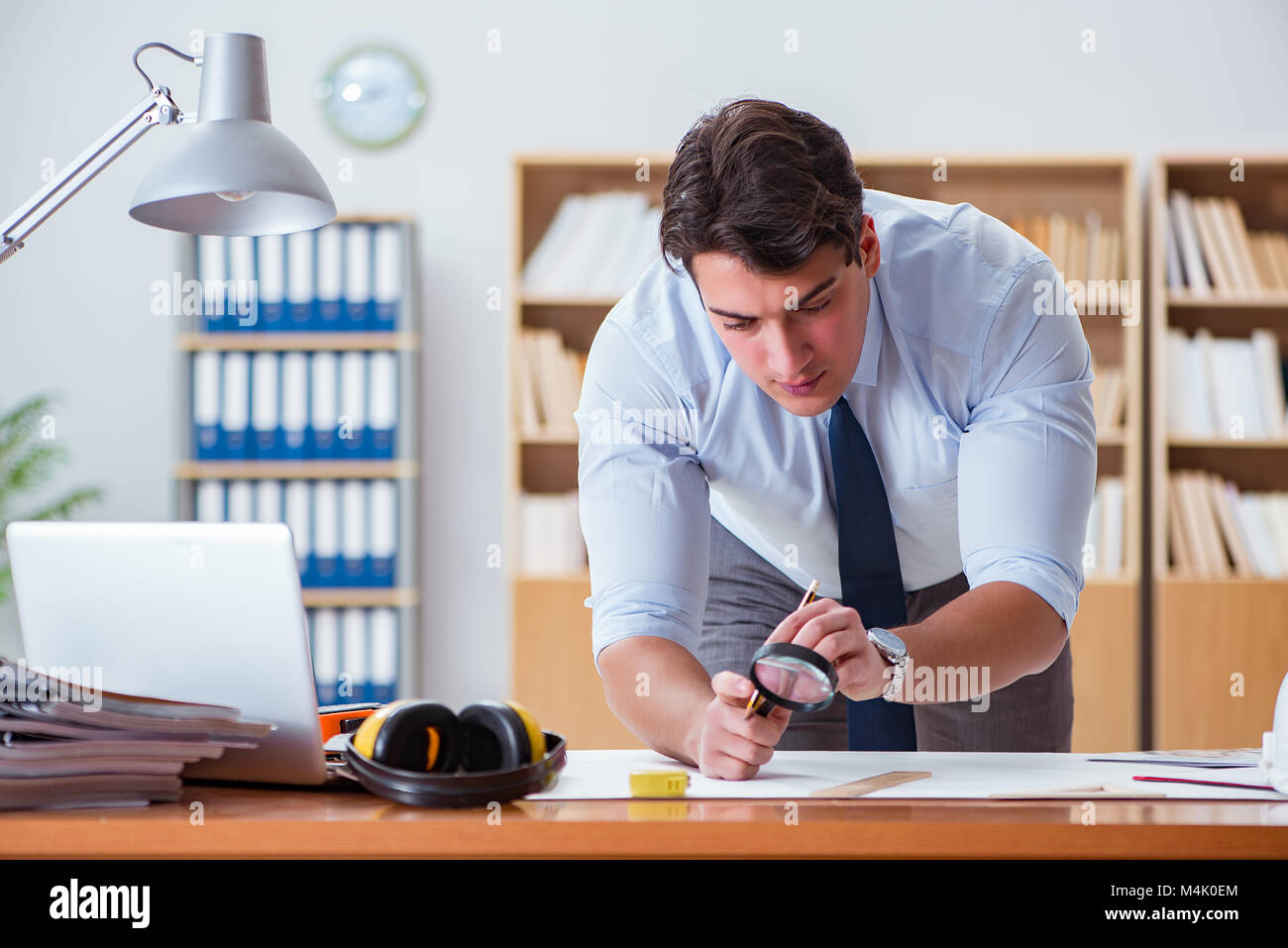 Engineer supervisor working on drawings in the office Stock Photo - Alamy
