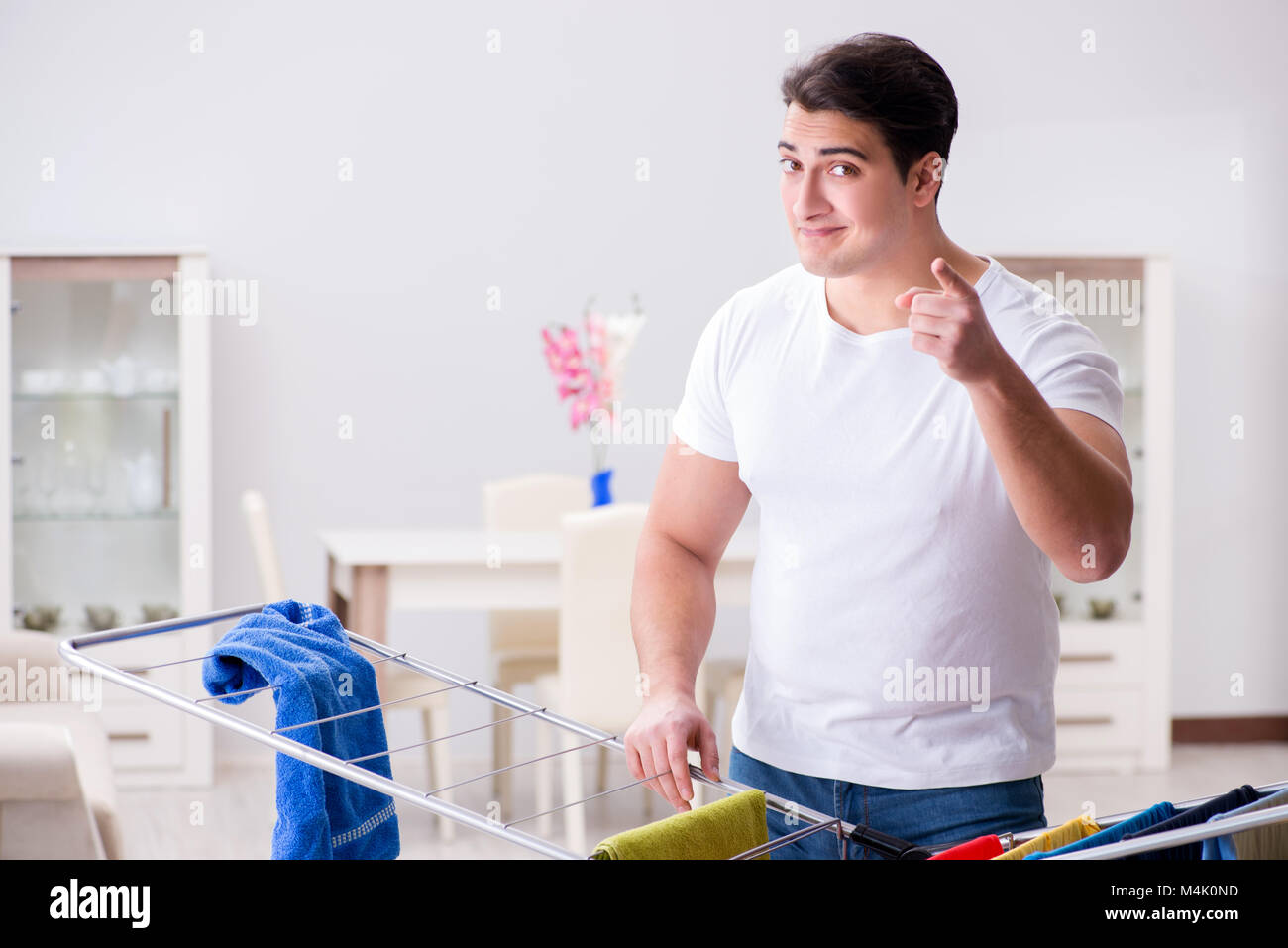 Man doing laundry at home Stock Photo - Alamy