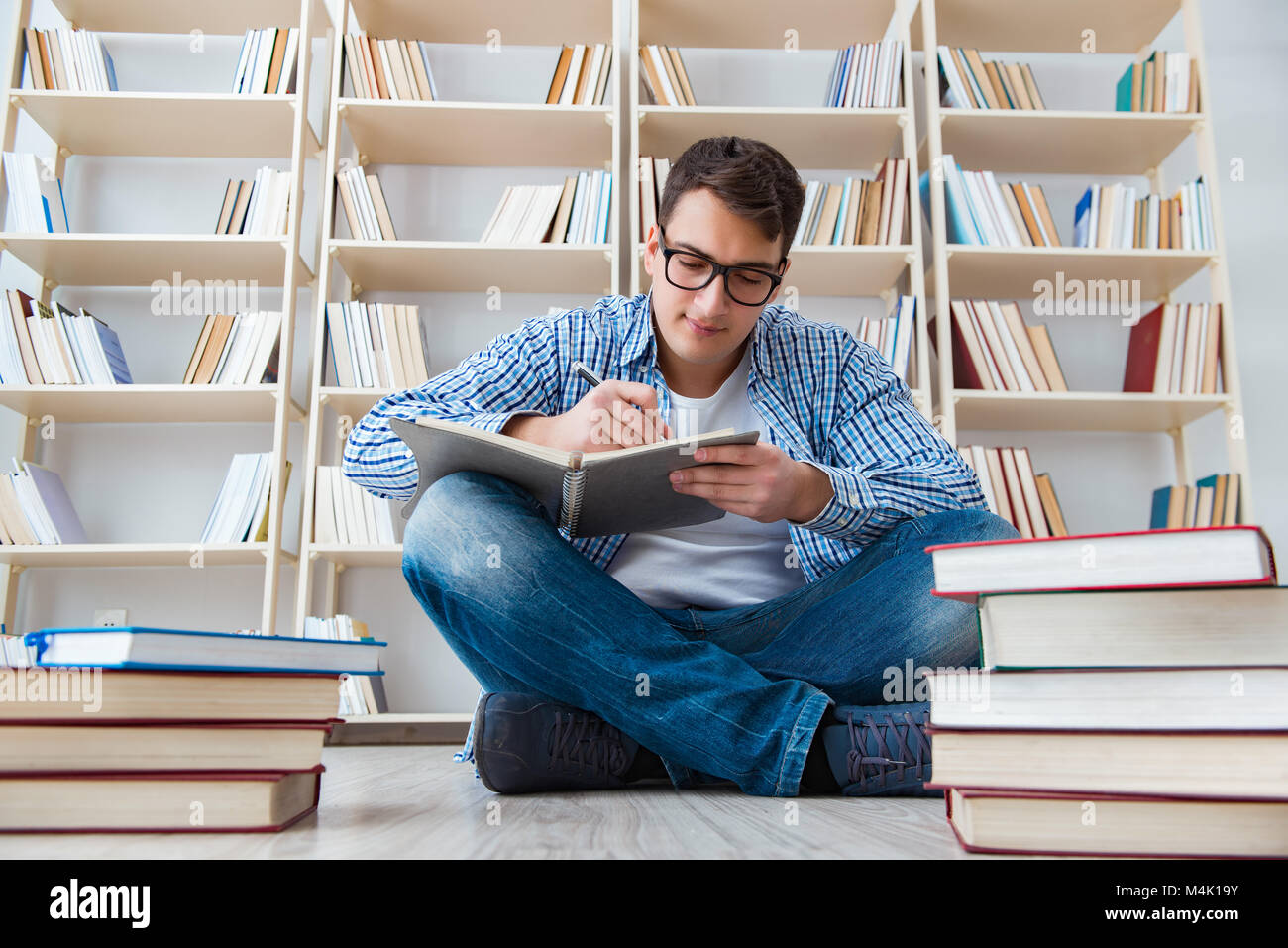 Young student studying with books Stock Photo - Alamy