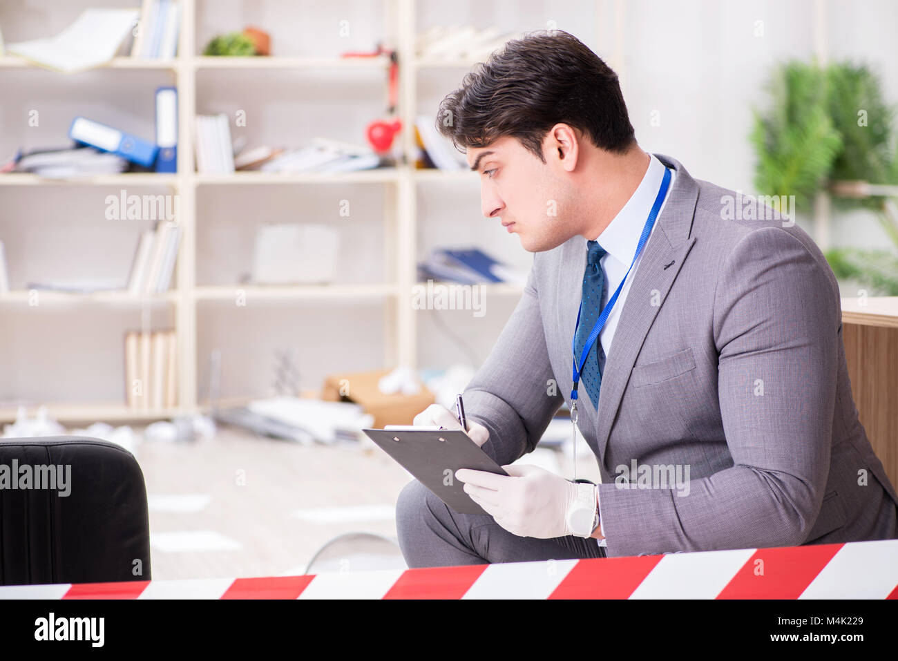 Young man during crime investigation in office Stock Photo - Alamy