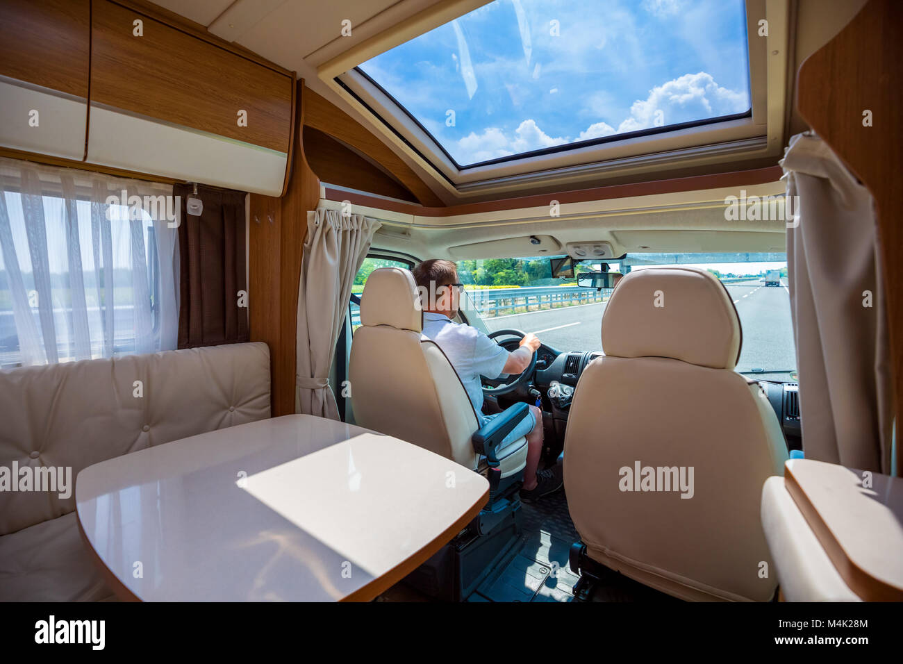 Man driving on a road in the Camper Van RV. Caravan car Vacation ...