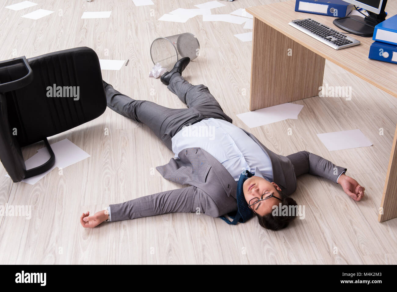 Businessman dead on the office floor Stock Photo - Alamy