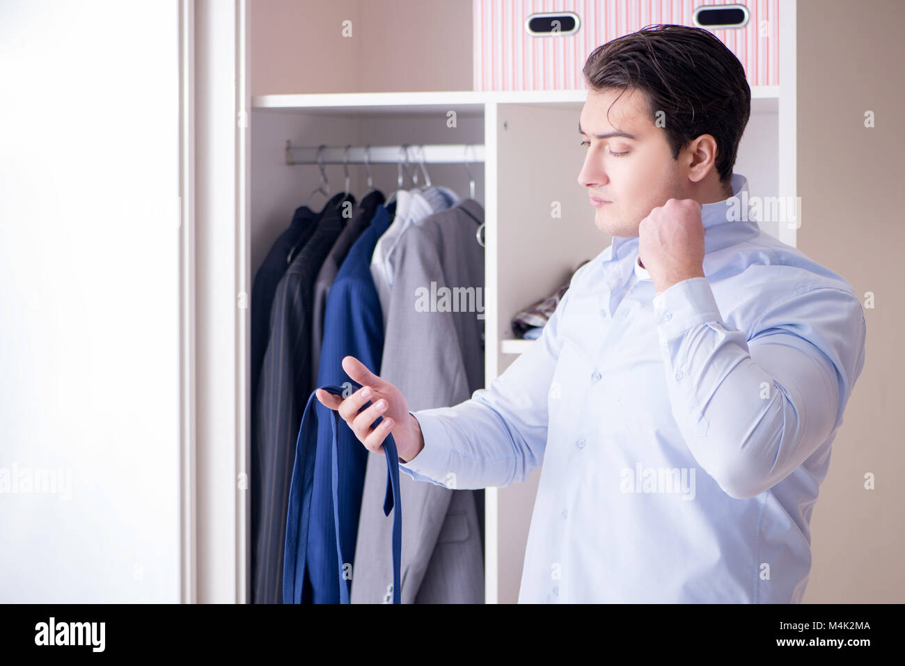 Young man businessman getting dressed for work Stock Photo - Alamy