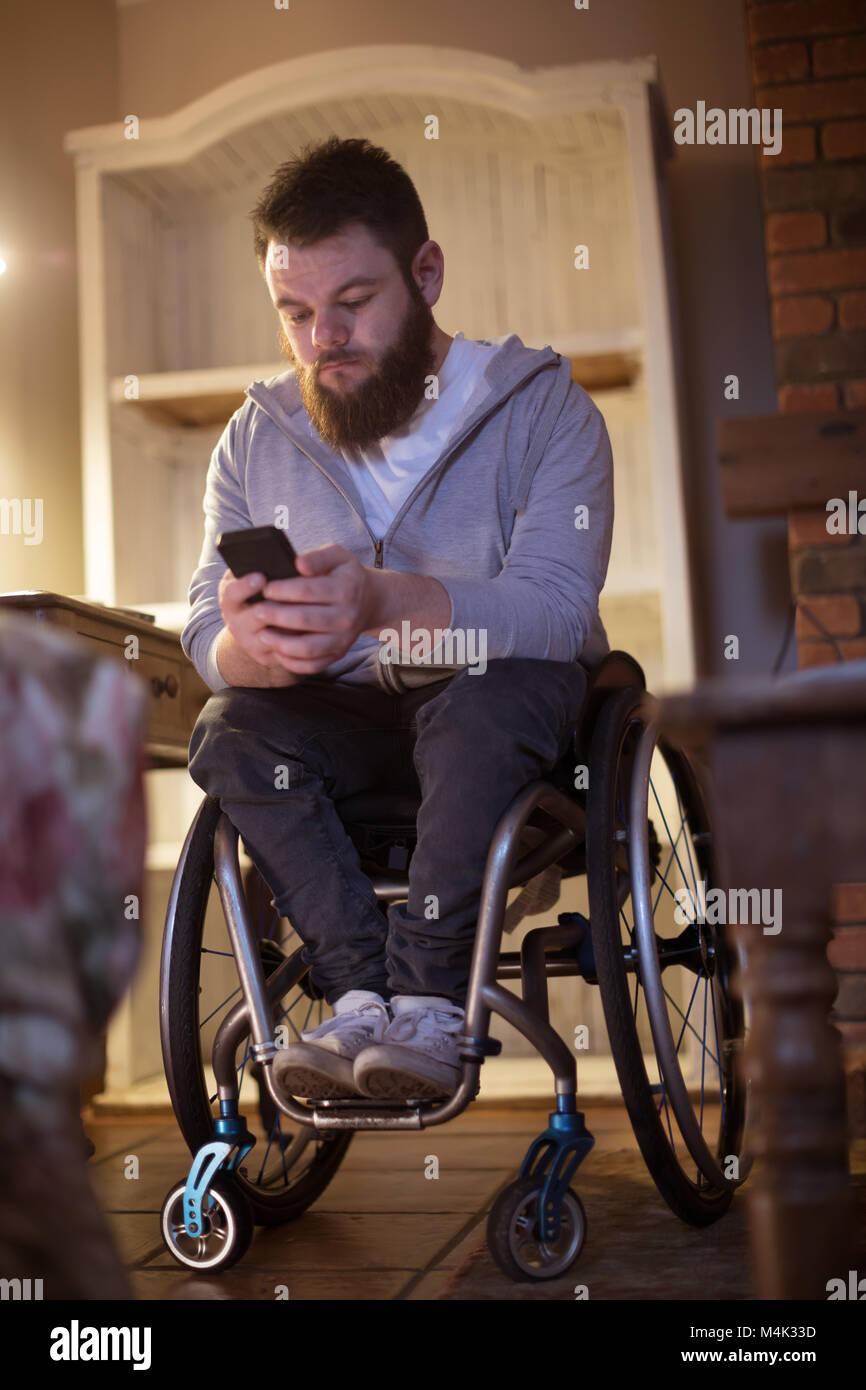 Disabled man using mobile phone Stock Photo - Alamy