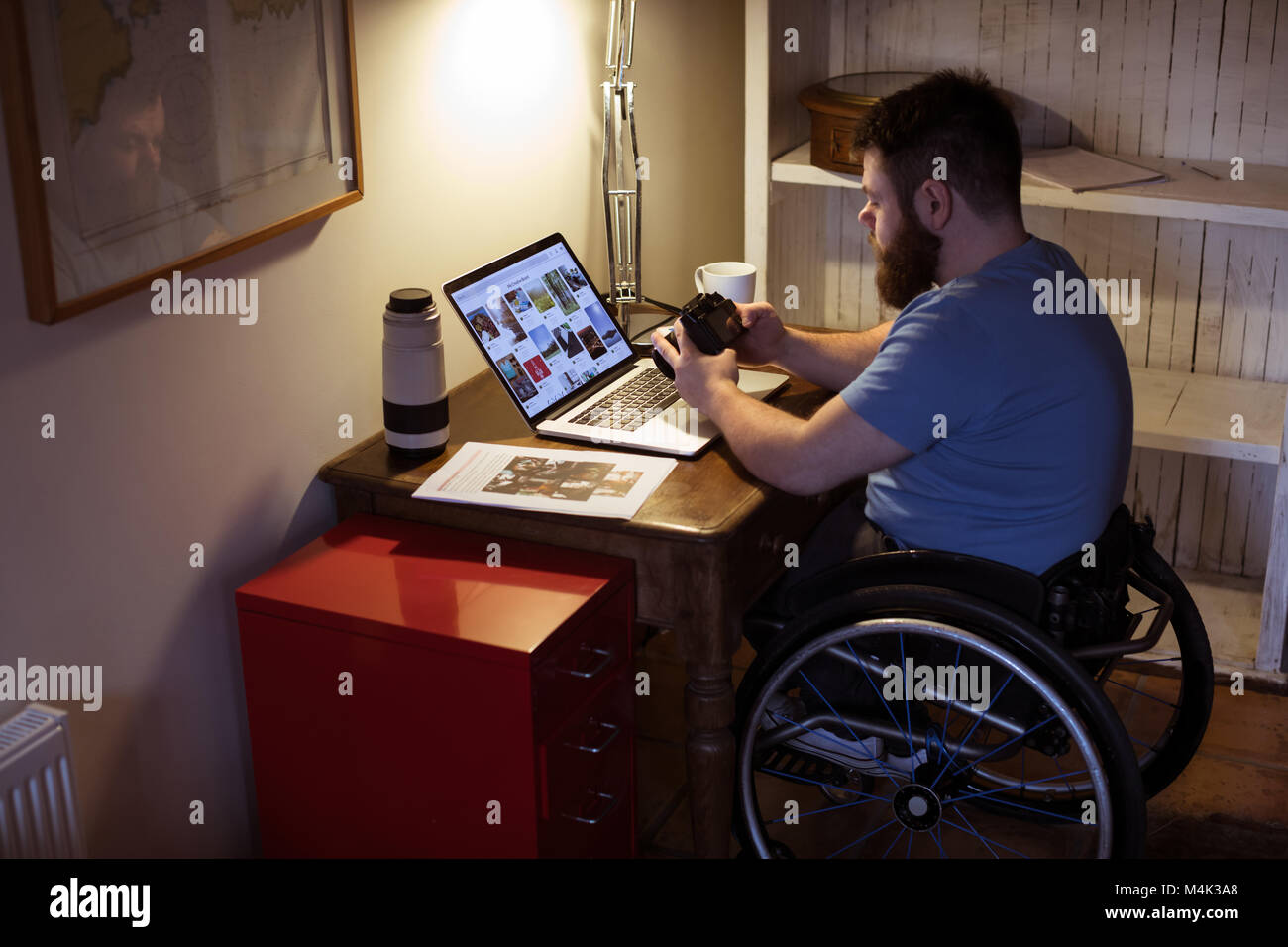 Disabled man looking at photos in camera Stock Photo - Alamy