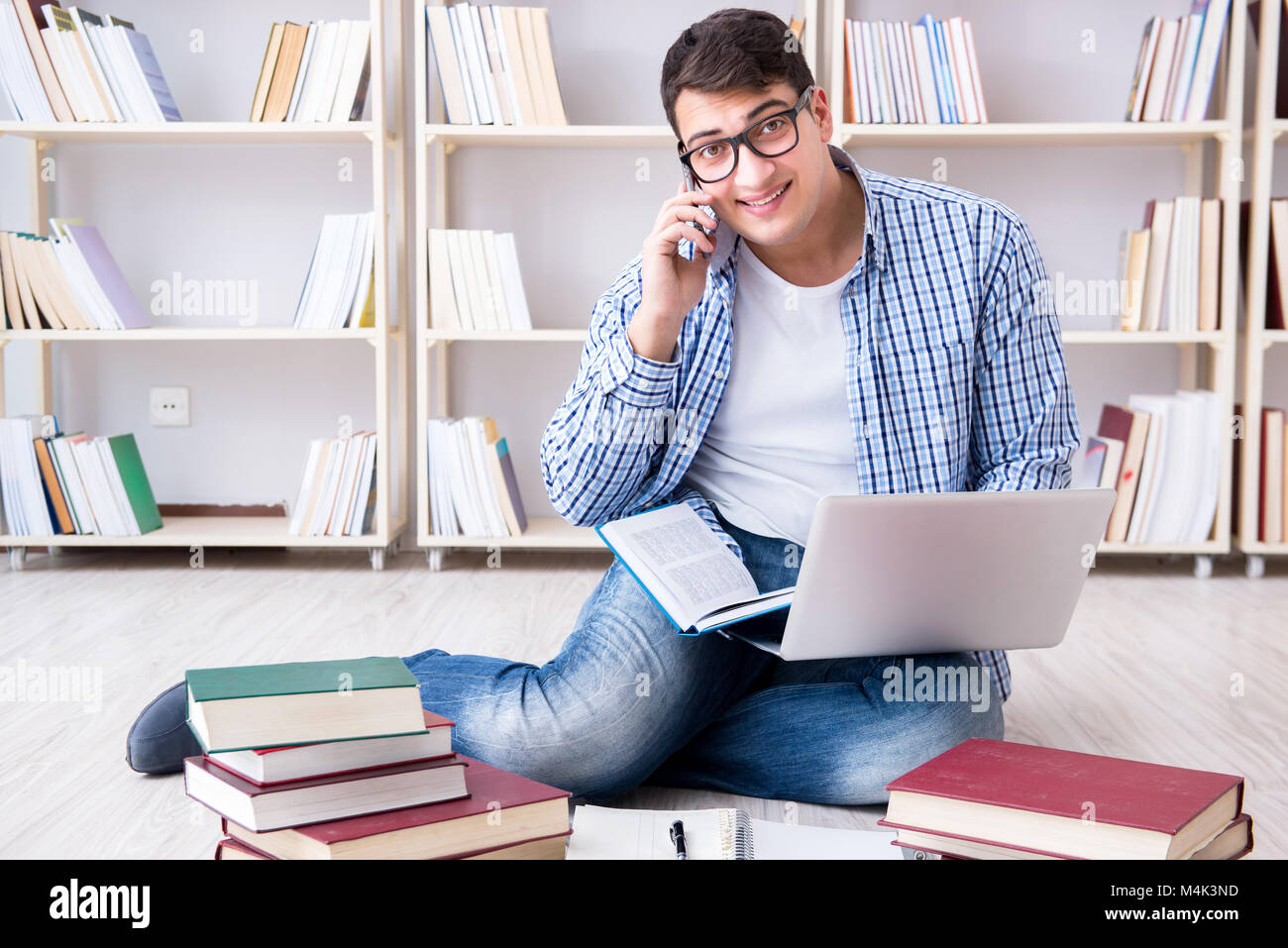 Young student studying with books Stock Photo - Alamy
