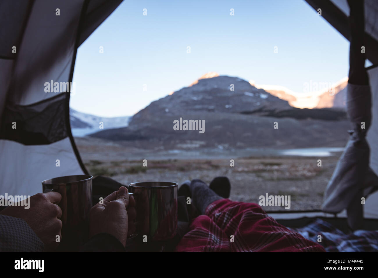 Couple having coffee in tent Stock Photo - Alamy