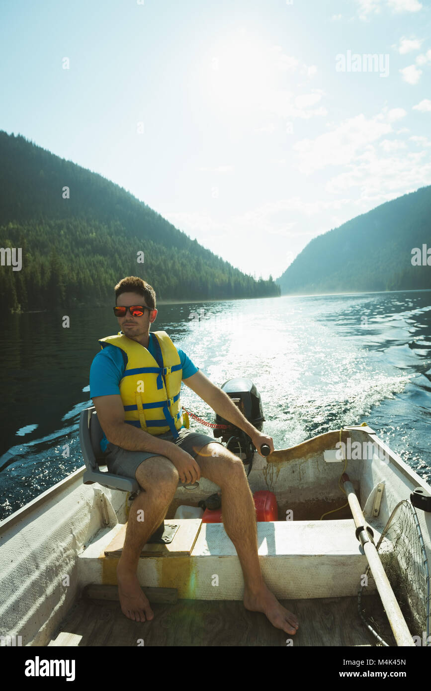 Man travelling on motorboat Stock Photo - Alamy