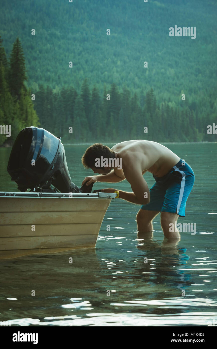 Man repairing a motorboat engine Stock Photo - Alamy