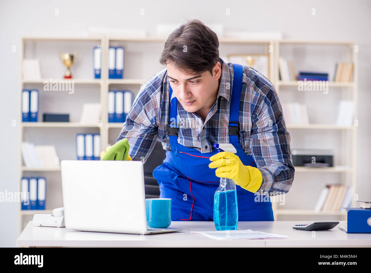 Cleaner man cleaning the office Stock Photo - Alamy