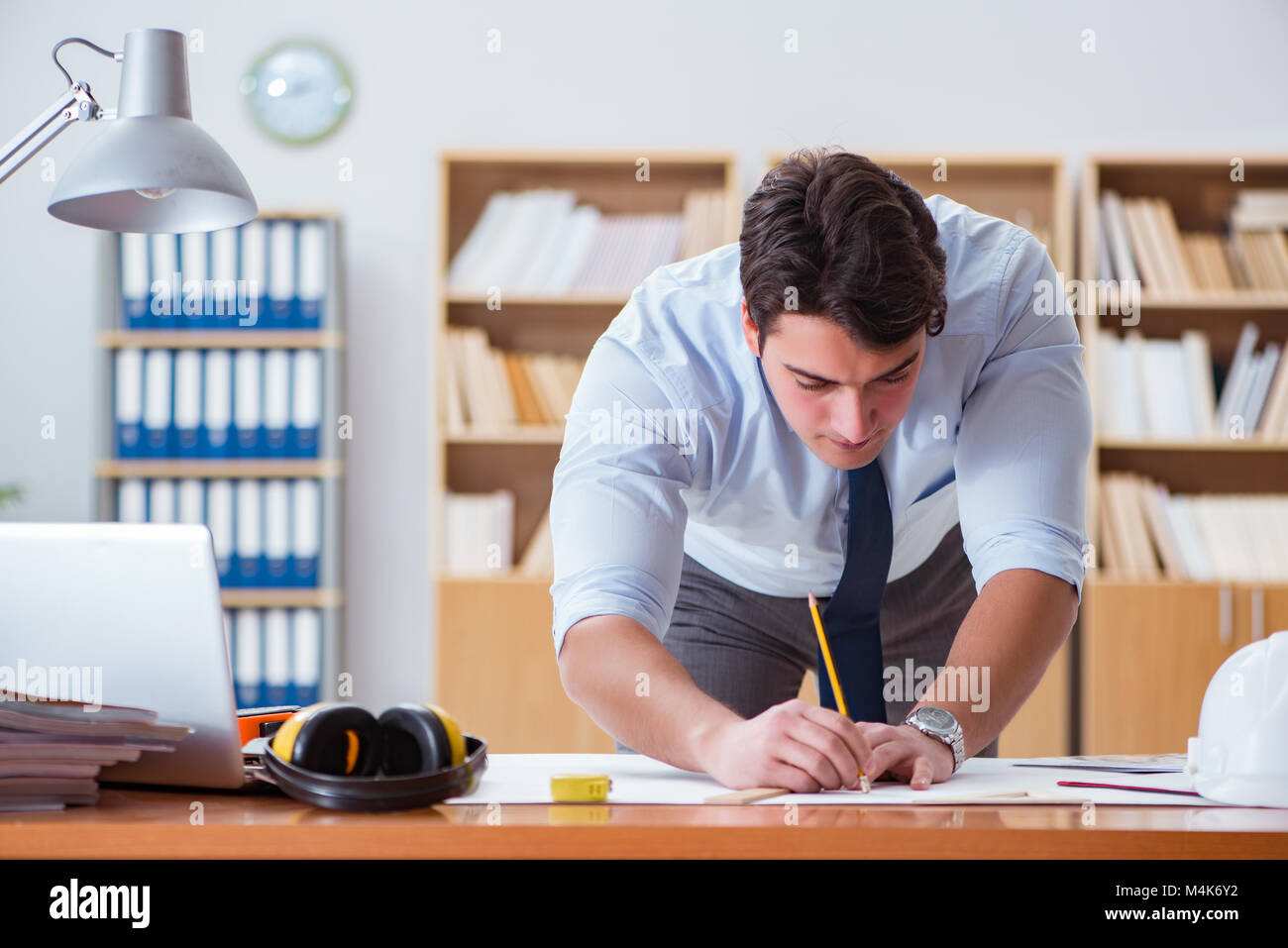 Engineer supervisor working on drawings in the office Stock Photo - Alamy