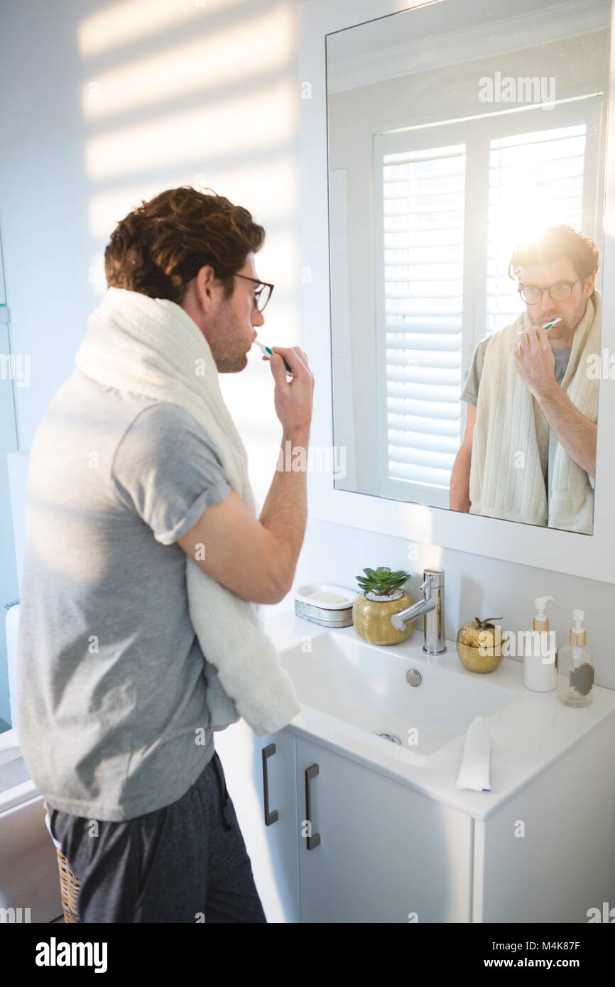 Man brushing his teeth in bathroom Stock Photo - Alamy