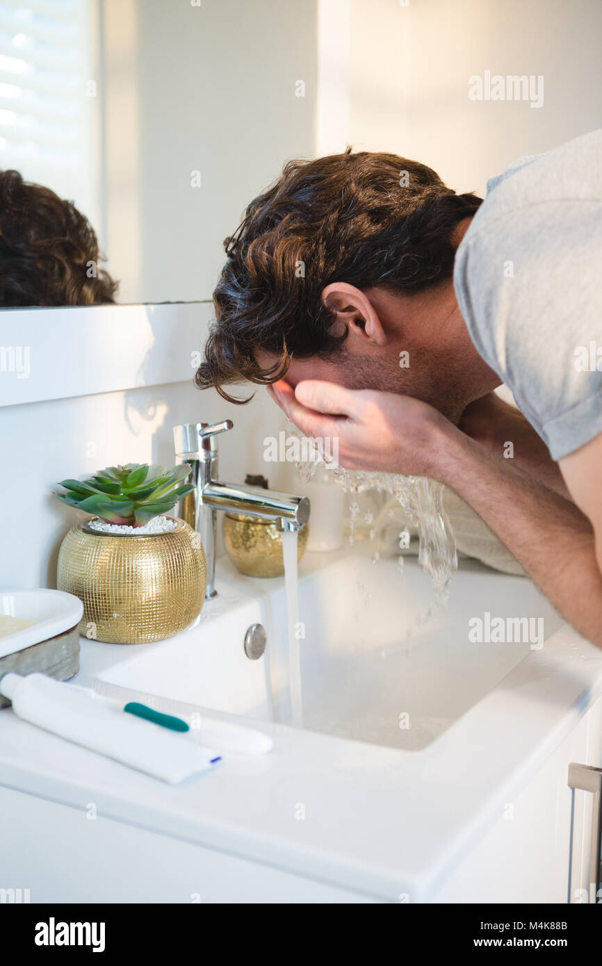 Man washing face in bathroom hi-res stock photography and images - Alamy