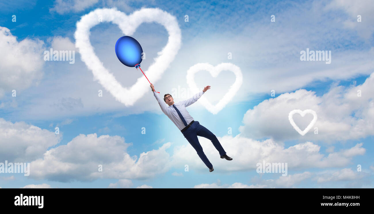 Man flying balloons in romantic concept Stock Photo - Alamy